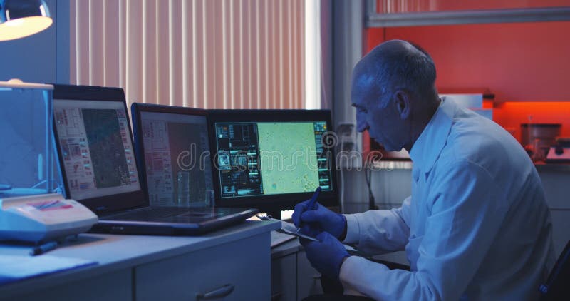 Scientist Taking Notes at Computer Screen Stock Photo - Image of ...