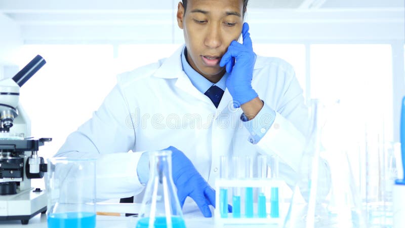 Scientist Talking on Phone in Laboratory Stock Photo - Image of ...