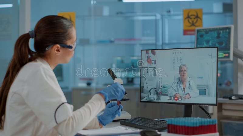 Scientist Talking To Expert on Video Call Conference in Laboratory ...