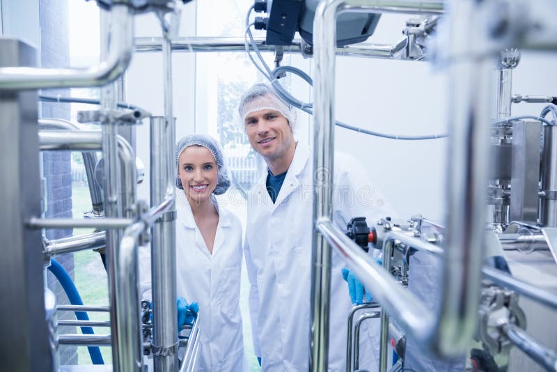 Scientist Team Behind Metal Gauge Looking at Camera Stock Photo - Image ...
