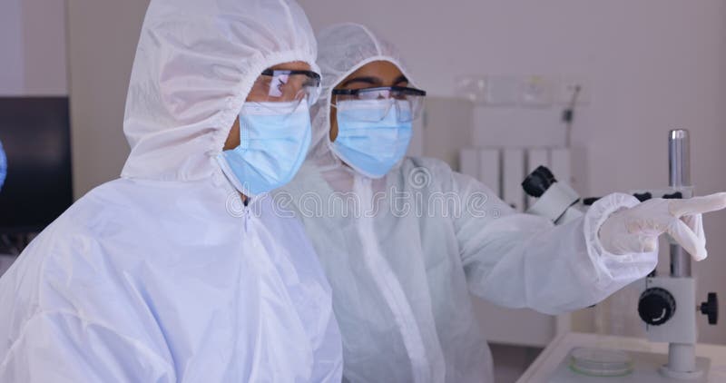 Scientist Team in Laboratory, PPE and Discussion with Computer and ...