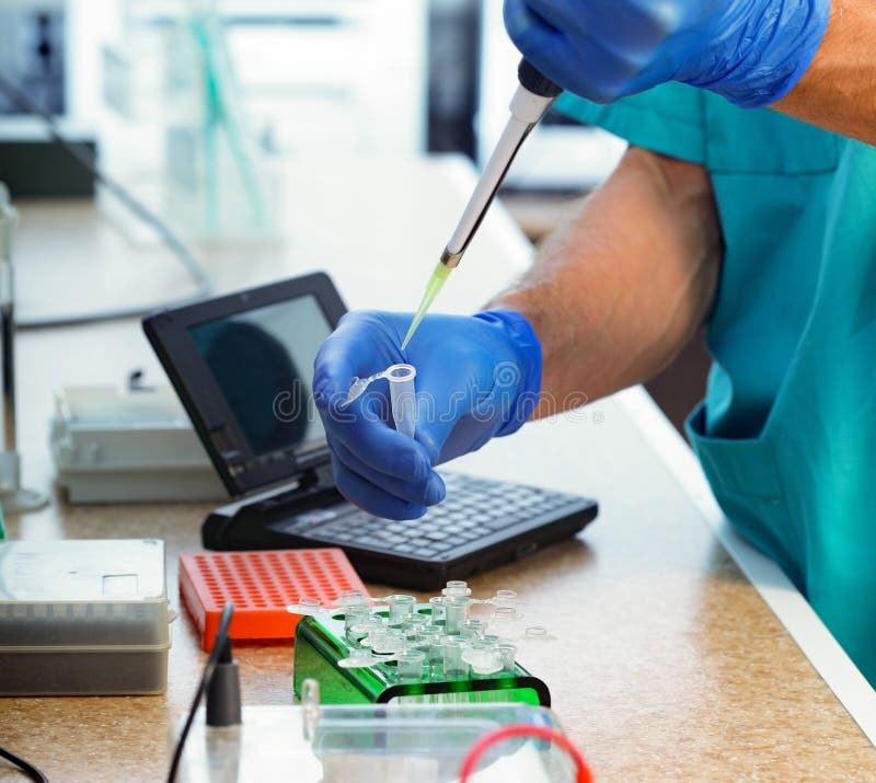 Scientist with Test Tubes and Flasks Conducting an Experiment in a ...
