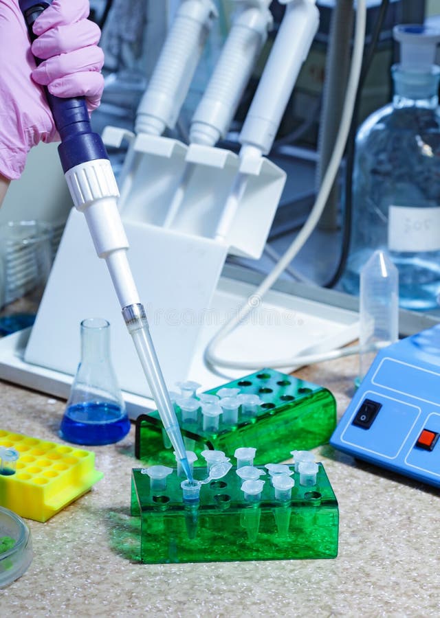 Scientist with Test Tubes and Flasks Conducting an Experiment in a ...
