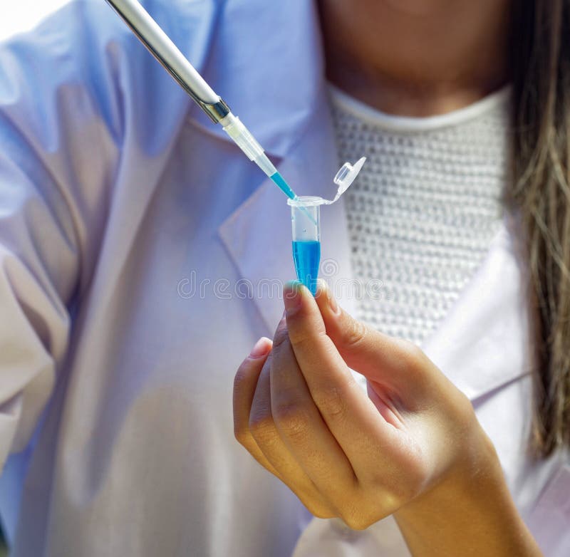 Scientist with Test Tubes and Flasks Conducting an Experiment in a ...