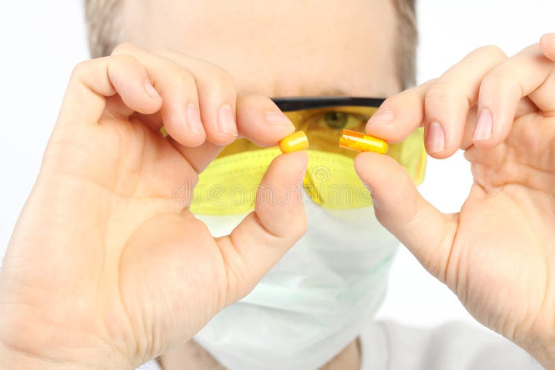 Scientist with Two Halves of Orange Capsule in His Hand on White ...