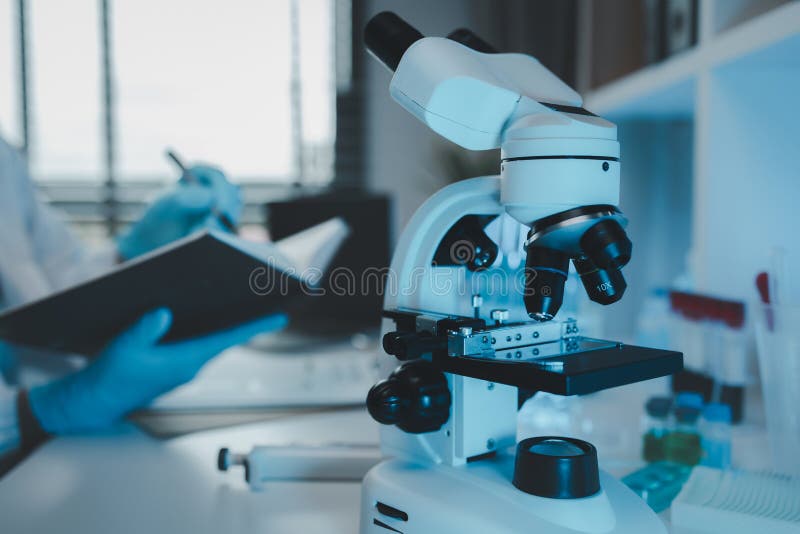 A Scientist Uses a Microscope To Look for Contaminants in a Test Sample ...