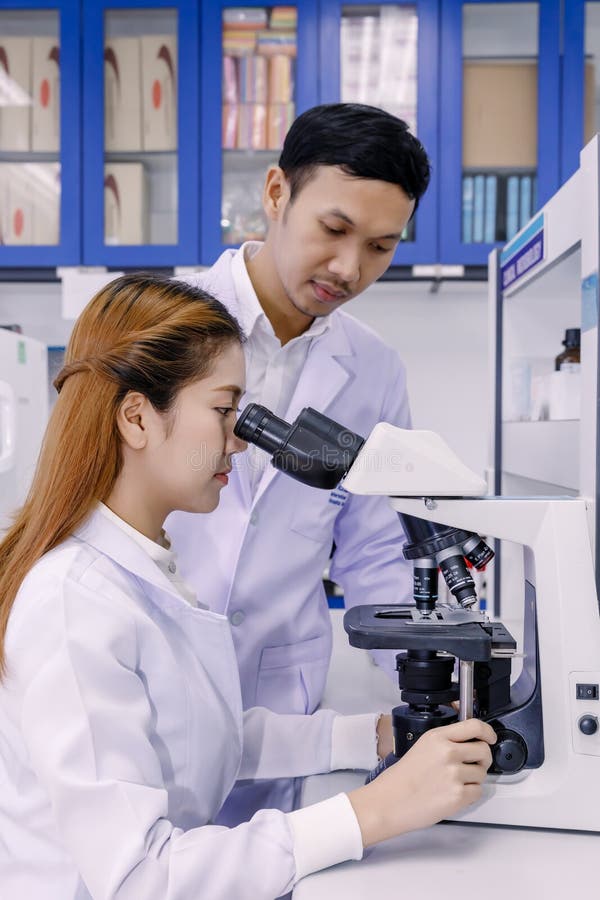 Scientist Using a Microscope in a Laboratory. Stock Image - Image of ...