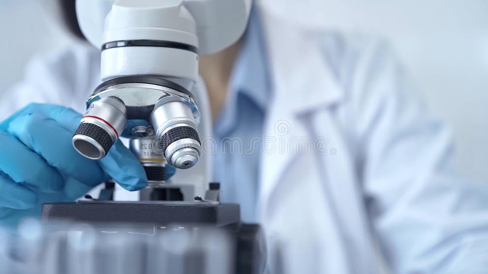 Scientist Using Microscope in Laboratory. Close-up of a Researcher S ...