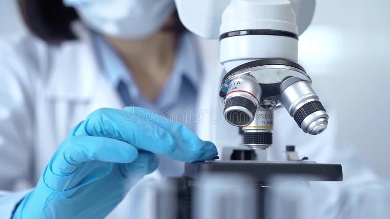 Scientist Using Microscope in Laboratory. Close-up of a Researcher S ...
