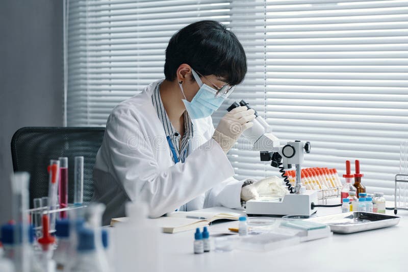 Scientist Using Microscope in Laboratory Research Setting Stock Photo ...