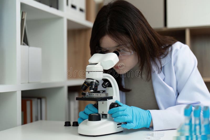 Scientist Using Microscope in Modern Laboratory for Research and ...