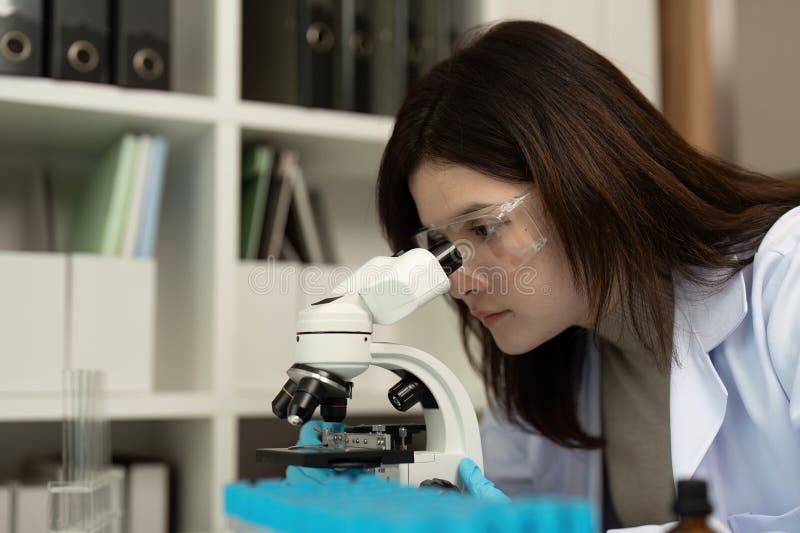 Scientist Using Microscope in Modern Laboratory for Research and ...