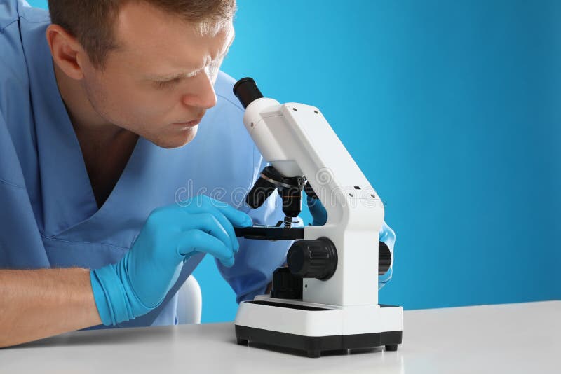 Scientist Using Modern Microscope at Table Against Background, Closeup ...