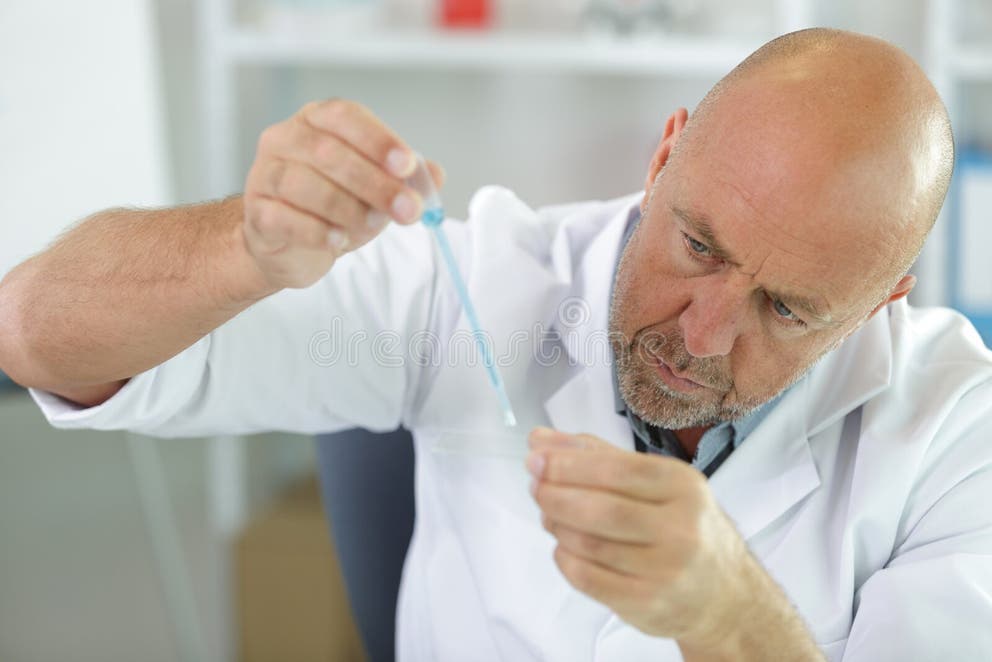 Scientist using pippete stock image. Image of biology - 261515245