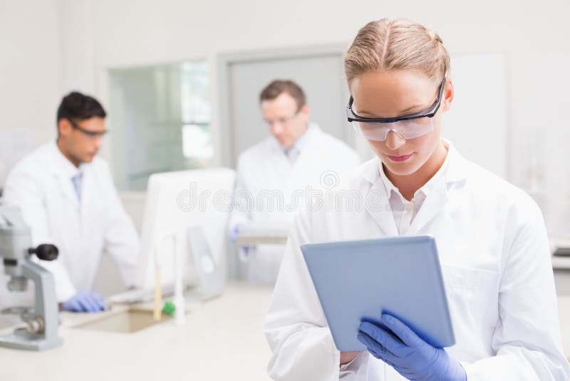 Scientist Using Modern Microscope at Table Against Background. Medical ...