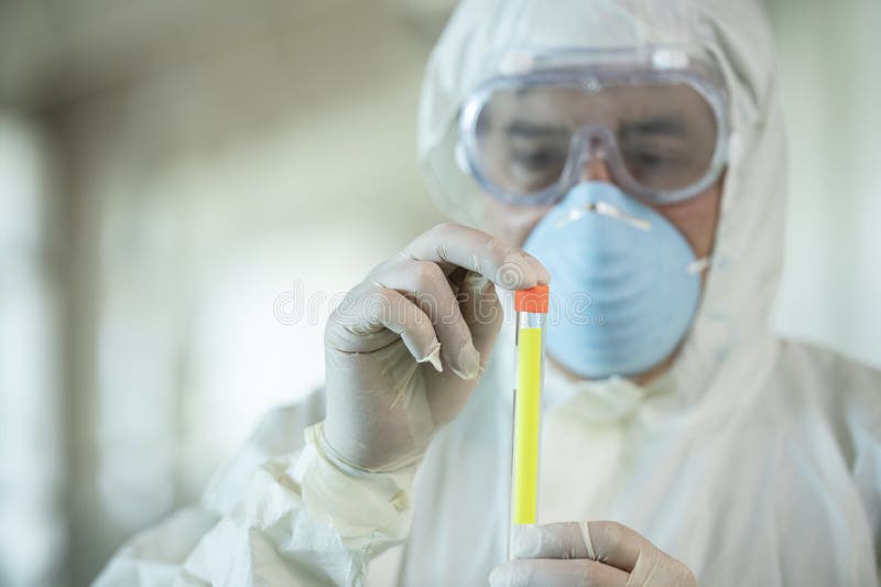 Scientist Wearing Protective Gear Holding a Test Result for Coronavirus ...