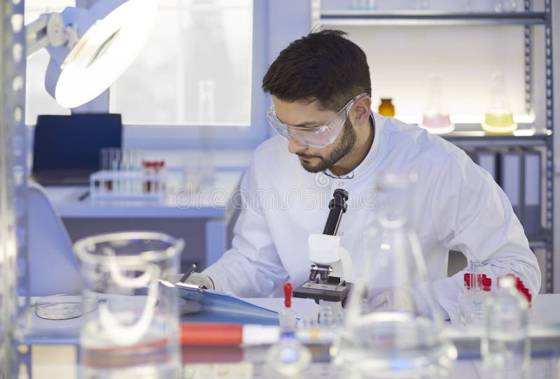 Scientist Reading Scientific Data Report while Doing Research in Modern ...