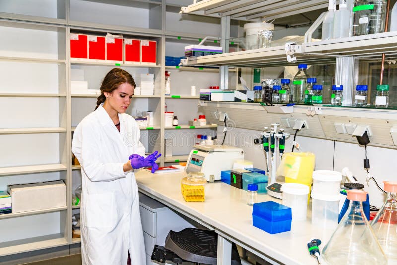 Scientist in White Lab Coat Standing by Equipment Stock Photo - Image ...