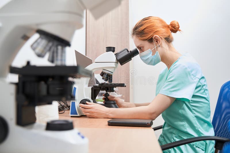 Scientist Working in the Hospital with Microscope Stock Photo - Image ...