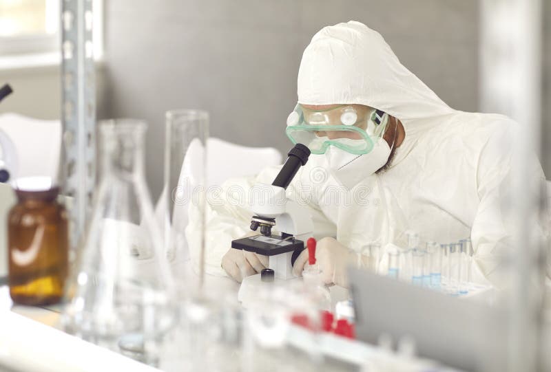 Scientist Working with Lab Microscope, Doing Research and Developing ...