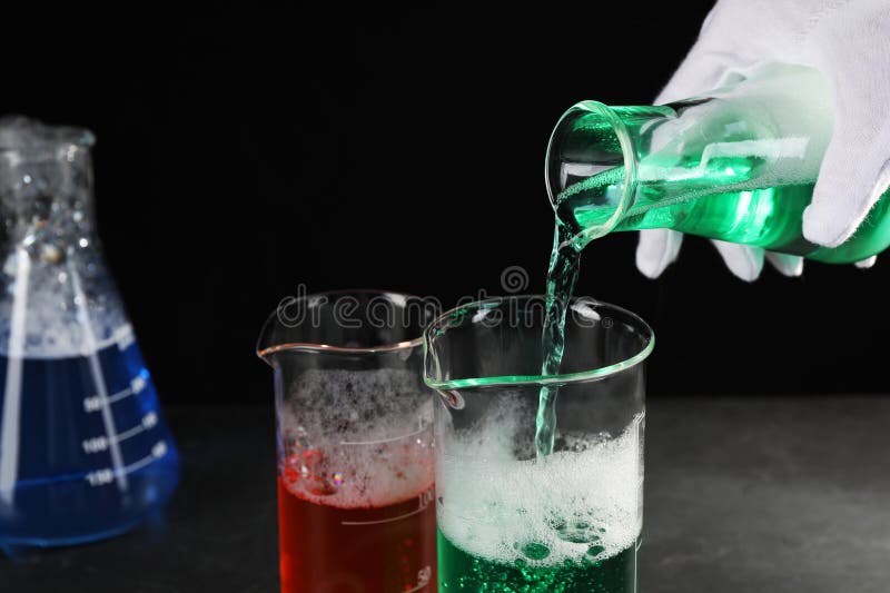Scientist Working with Laboratory Glassware at Black Table, Closeup ...