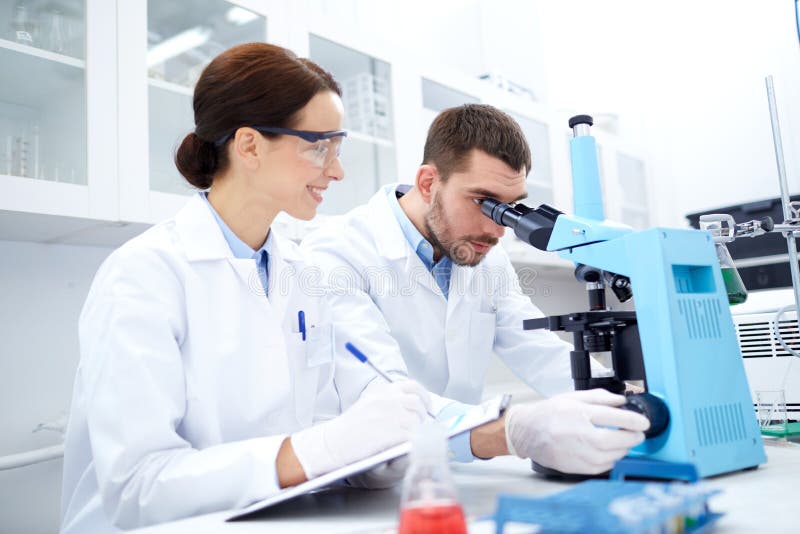 Scientists with Microscope Making Research in Lab Stock Image - Image ...