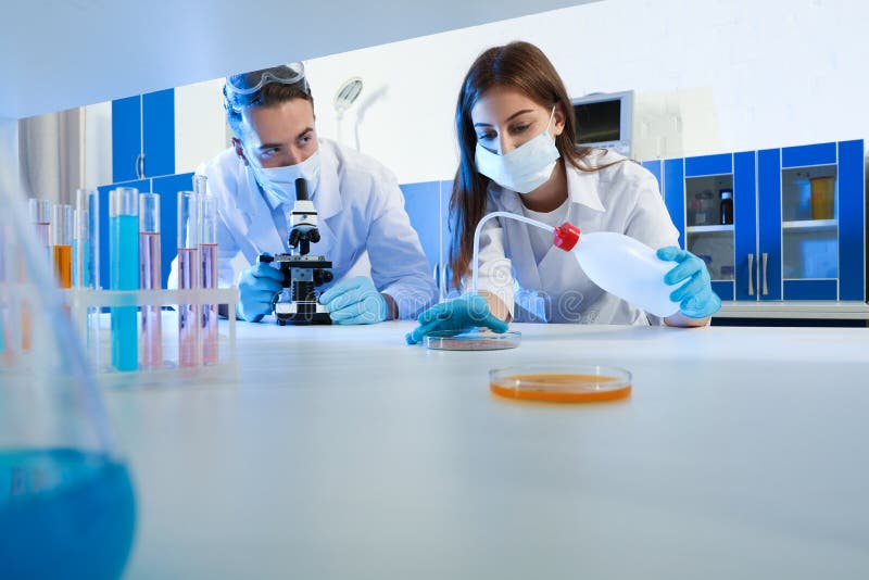 Scientists Doing Research and Analysis with Microscope Stock Image ...