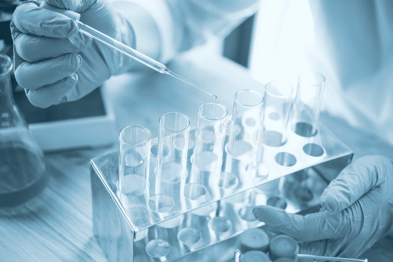 Scientists are Dripping Liquid into the Test Tube.Research in Lab ...