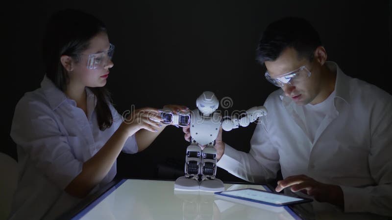 Scientists Engineers Woman and Man Check Functionality of Smart Robot ...
