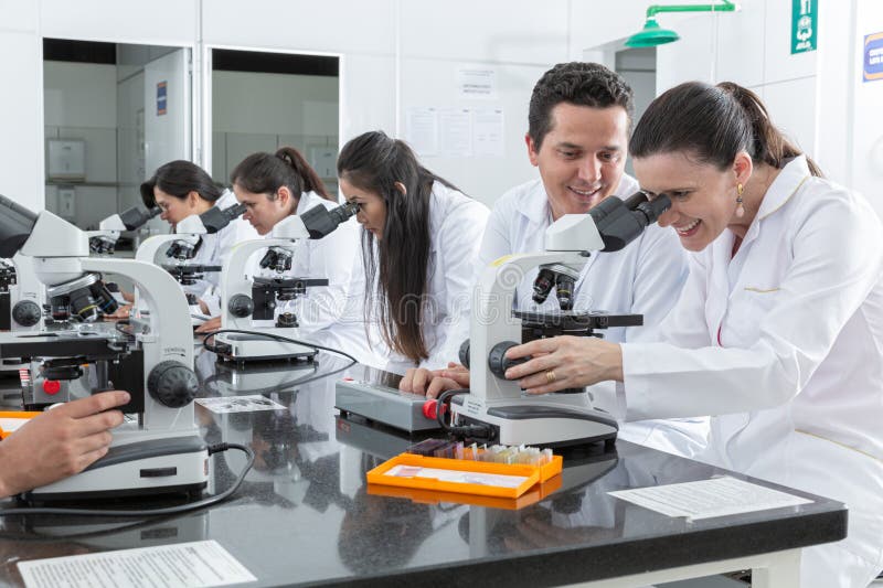 Scientists Examining Microscope, in Laboratory Room Stock Image - Image ...