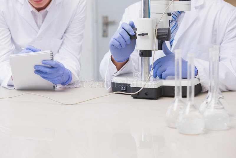 Scientists Examining Something with the Microscope Stock Image - Image ...