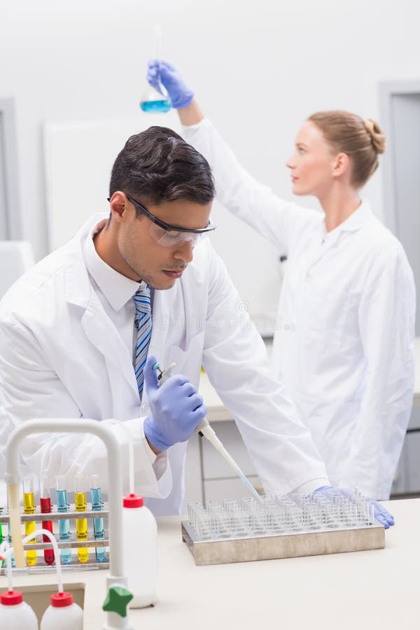Scientists Examining Tubes and Baker Stock Image - Image of indoors ...