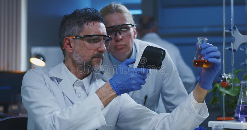Scientists Examining Various Liquids Stock Photo - Image of ...
