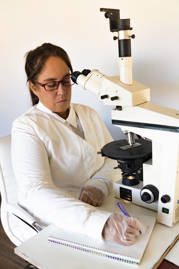 Scientist Writing Next To the Microscope Stock Photo - Image of ...