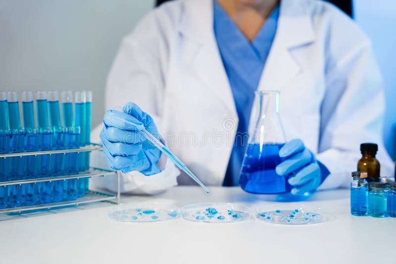 Scientists Hold Test Tubes for Analysis. Experiments with Red Liquid ...