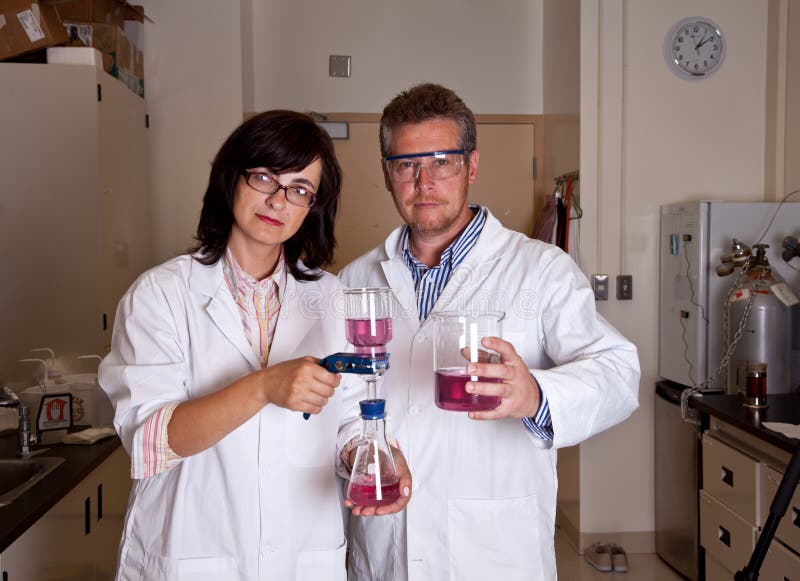 Scientists holding labware stock photo. Image of holding - 27631040
