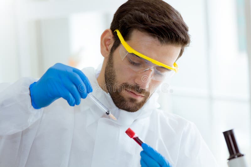 Scientists in Laboratory Conducting Analyzing, Experiment a Blood ...