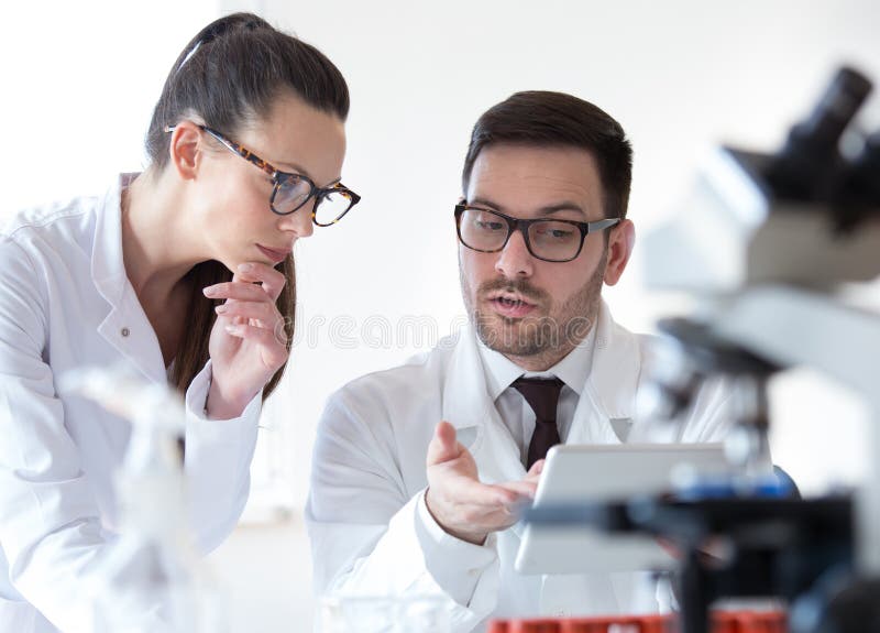Scientists in Laboratory with Microscope Stock Image - Image of science ...