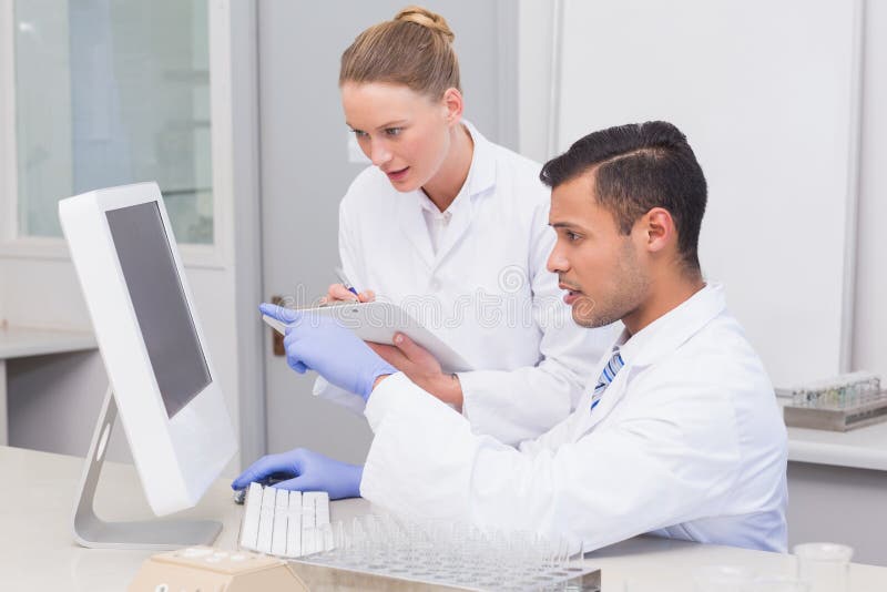 Scientists Looking at Computer Stock Photo - Image of gloves, adult ...