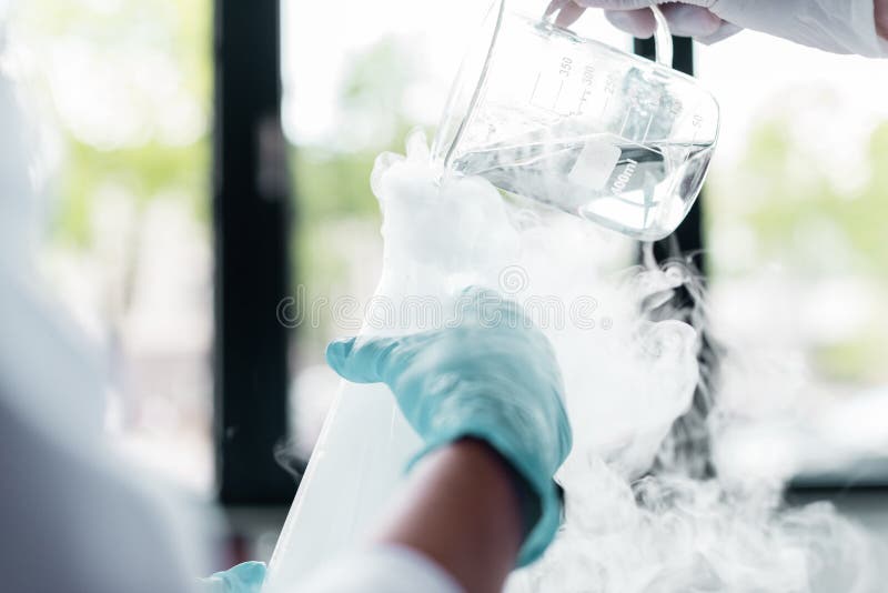 Scientists Making Experiment with Reagent and Flasks Stock Image ...