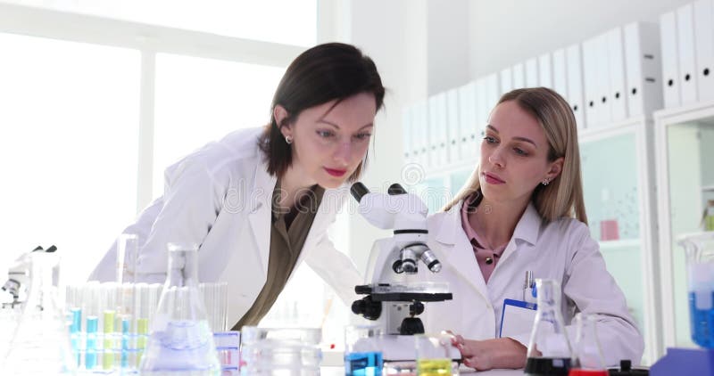 Scientists with Microscope Perform Tests or Research in Clinical ...
