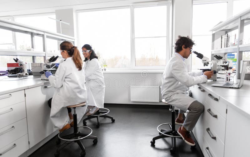 Scientists with Microscopes Working in Laboratory Stock Photo - Image ...