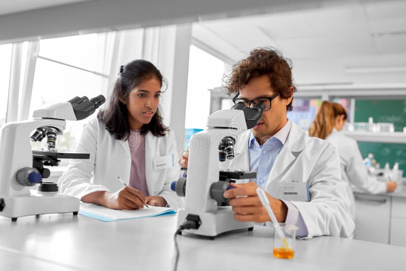Scientists with Microscopes Working in Laboratory Stock Image - Image ...