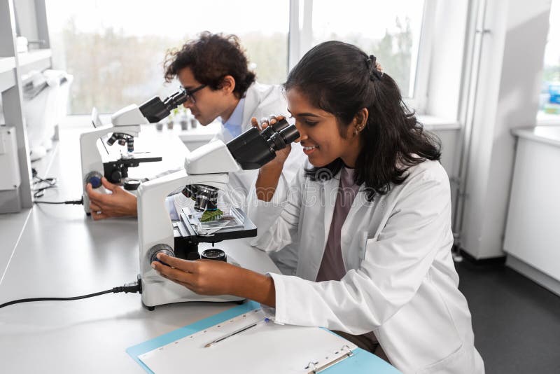Scientists with Microscopes Working in Laboratory Stock Photo - Image ...