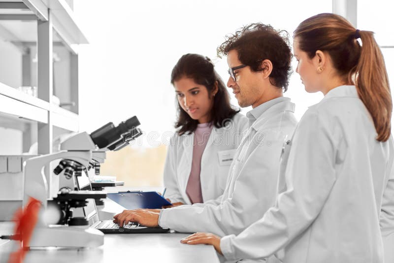Scientists with Microscopes Working in Laboratory Stock Image - Image ...