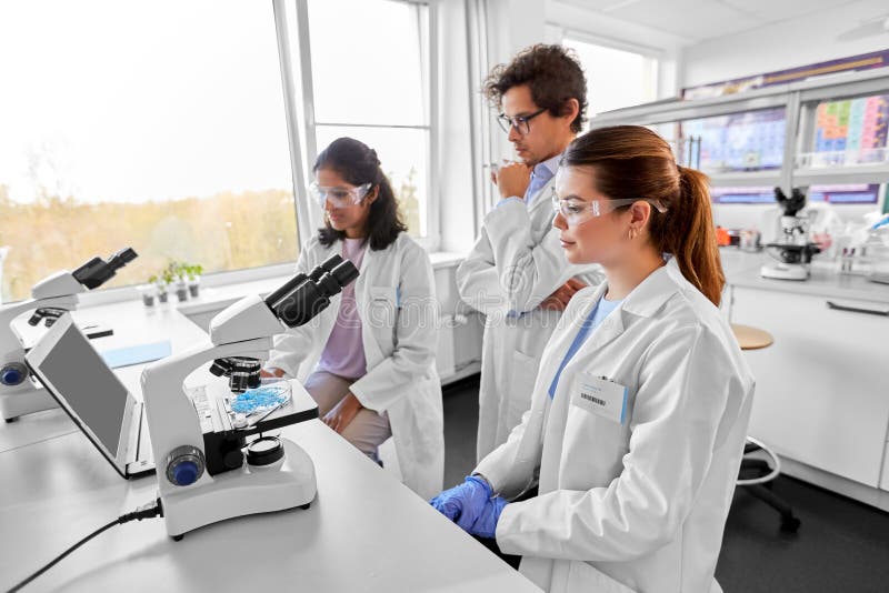 Scientists with Microscopes Working in Laboratory Stock Photo - Image ...