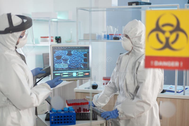 Scientists in Ppe Suit Talking Behind the Glass Wall Working in Danger ...