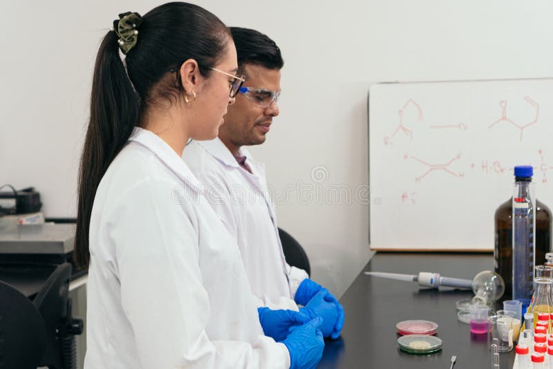 Scientists Preparing for Laboratory Work. Lab Technicians Putting on ...