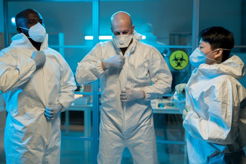 Scientists Putting on Biohazard Suits while Standing in Front of ...