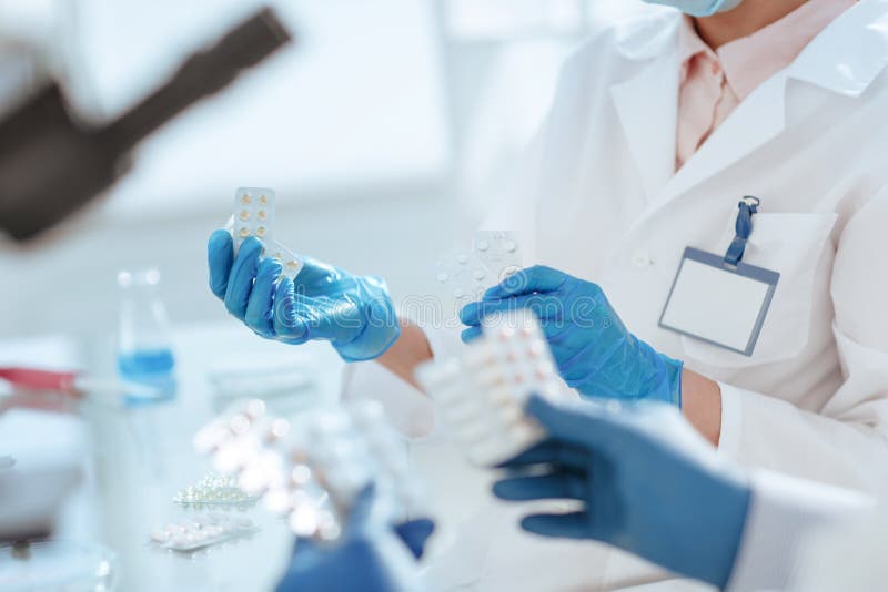 Scientists with Samples of New Drugs Sitting at a Laboratory Table ...